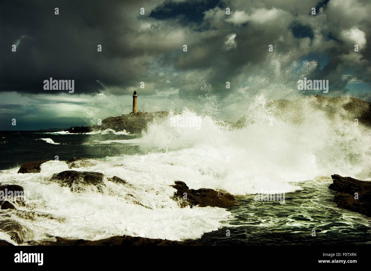 View of Ardnamurchan Point lighthouse amidst stormy sea and sky ...