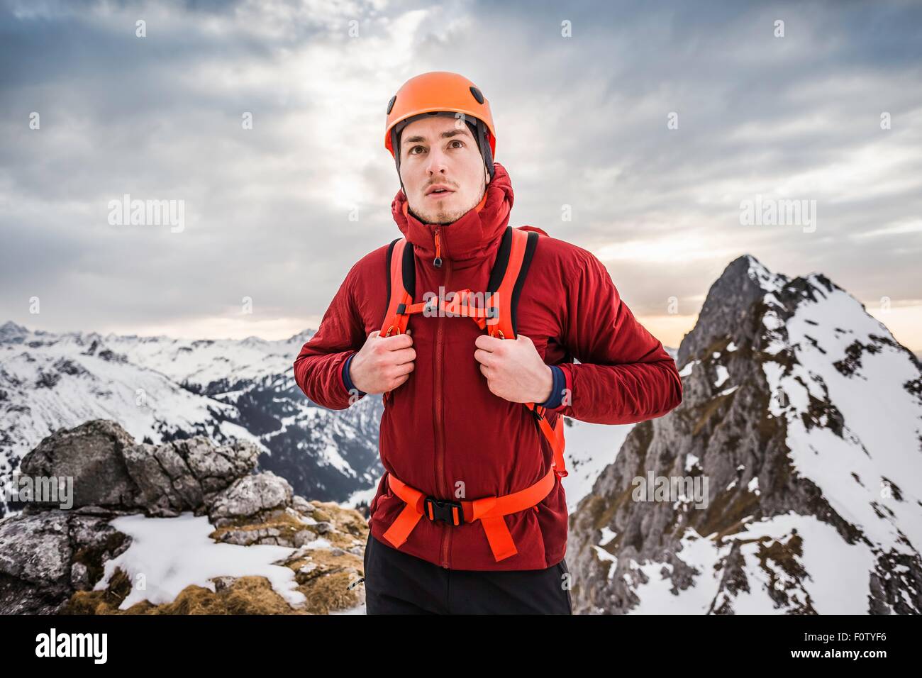 Hiker wearing helmet on mountain, Kellenspitze, Tannheim mountains ...