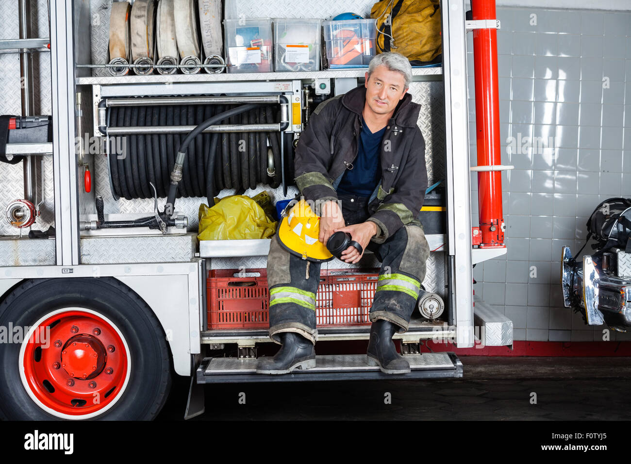 Fire Men Sitting In Fire Truck High Resolution Stock Photography and ...