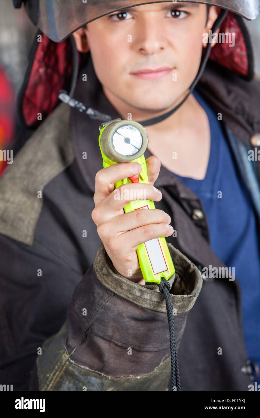 Confident Fireman Holding Torch At Fire Station Stock Photo - Alamy