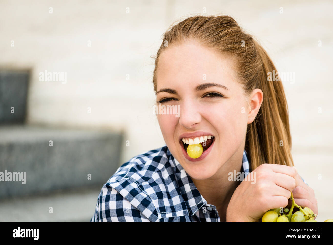 Woman eating grapes hi-res stock photography and images - Alamy