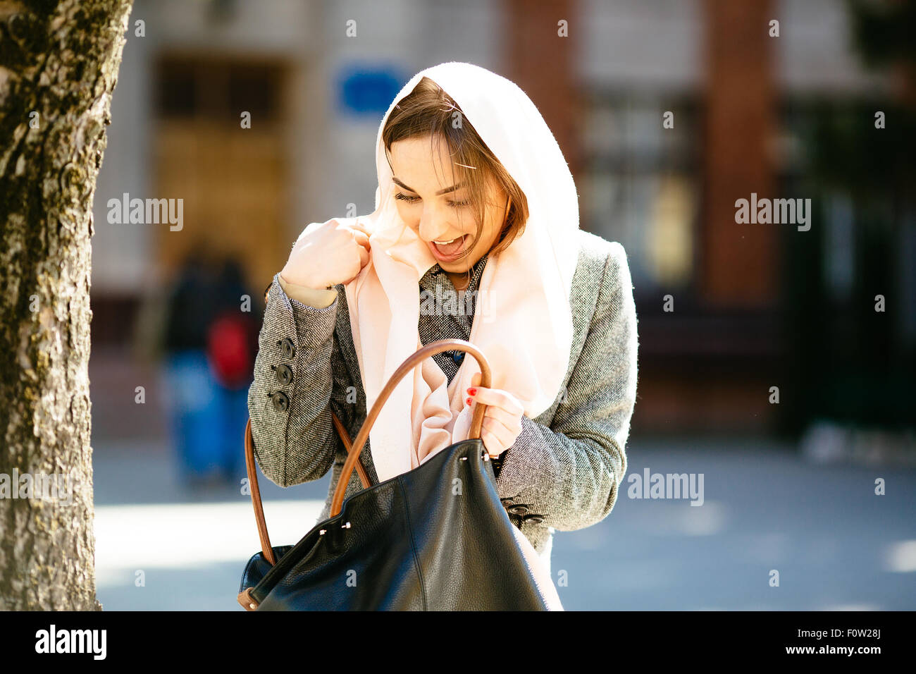 girl looking for something in a bag Stock Photo - Alamy