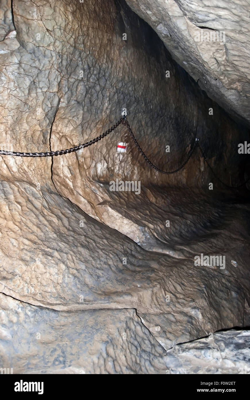 rad marks of hiking trail and chain inside Jaskinia Mylna cave in Tatry ...