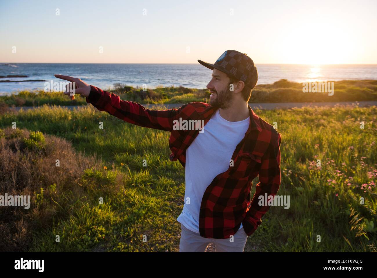 Man pointing out out sea hi-res stock photography and images - Alamy