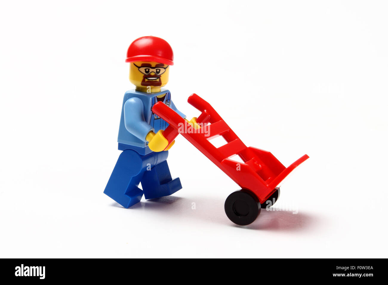 toy man whit hand truck on white background Stock Photo - Alamy