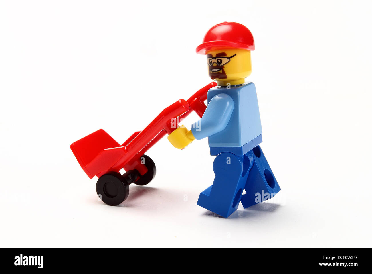 toy man whit hand truck on white background Stock Photo - Alamy