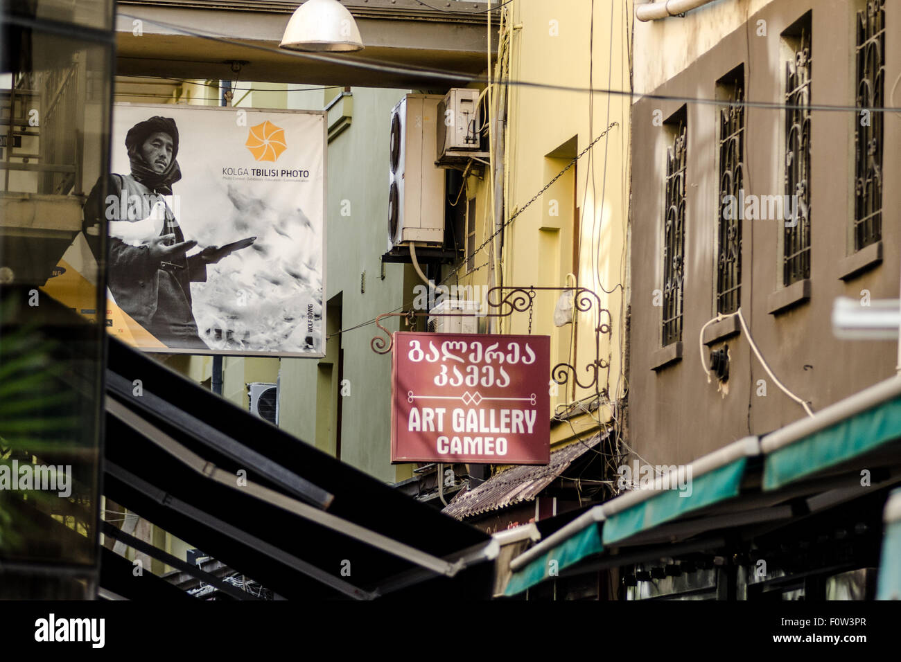 Art galleries and vibrant street life in a bustling urban alley in ...