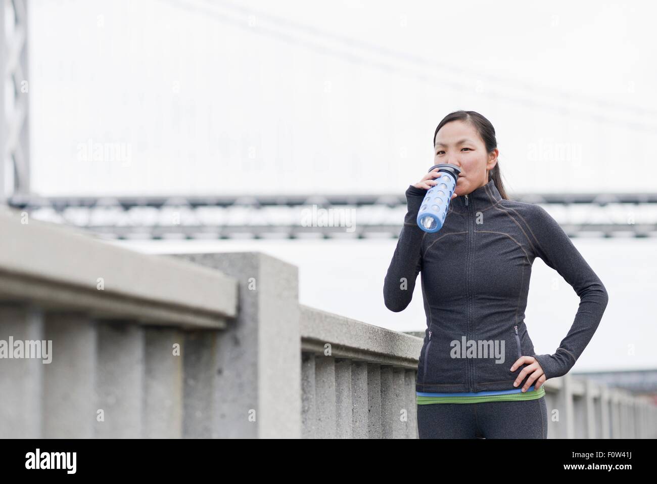 Female runner drinking on bridge, San Francisco, California Stock Photo ...