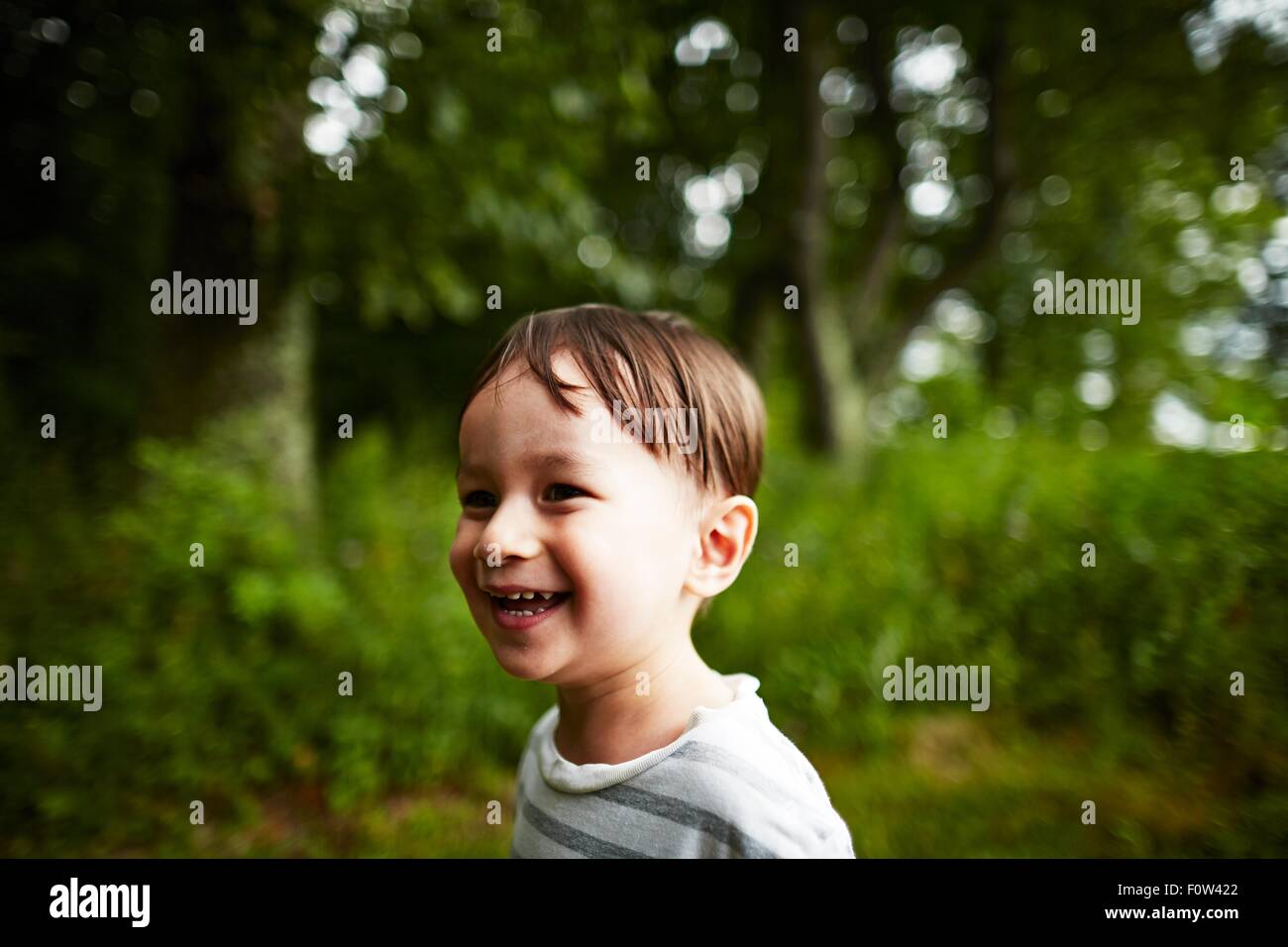 Boy in forest Stock Photo - Alamy