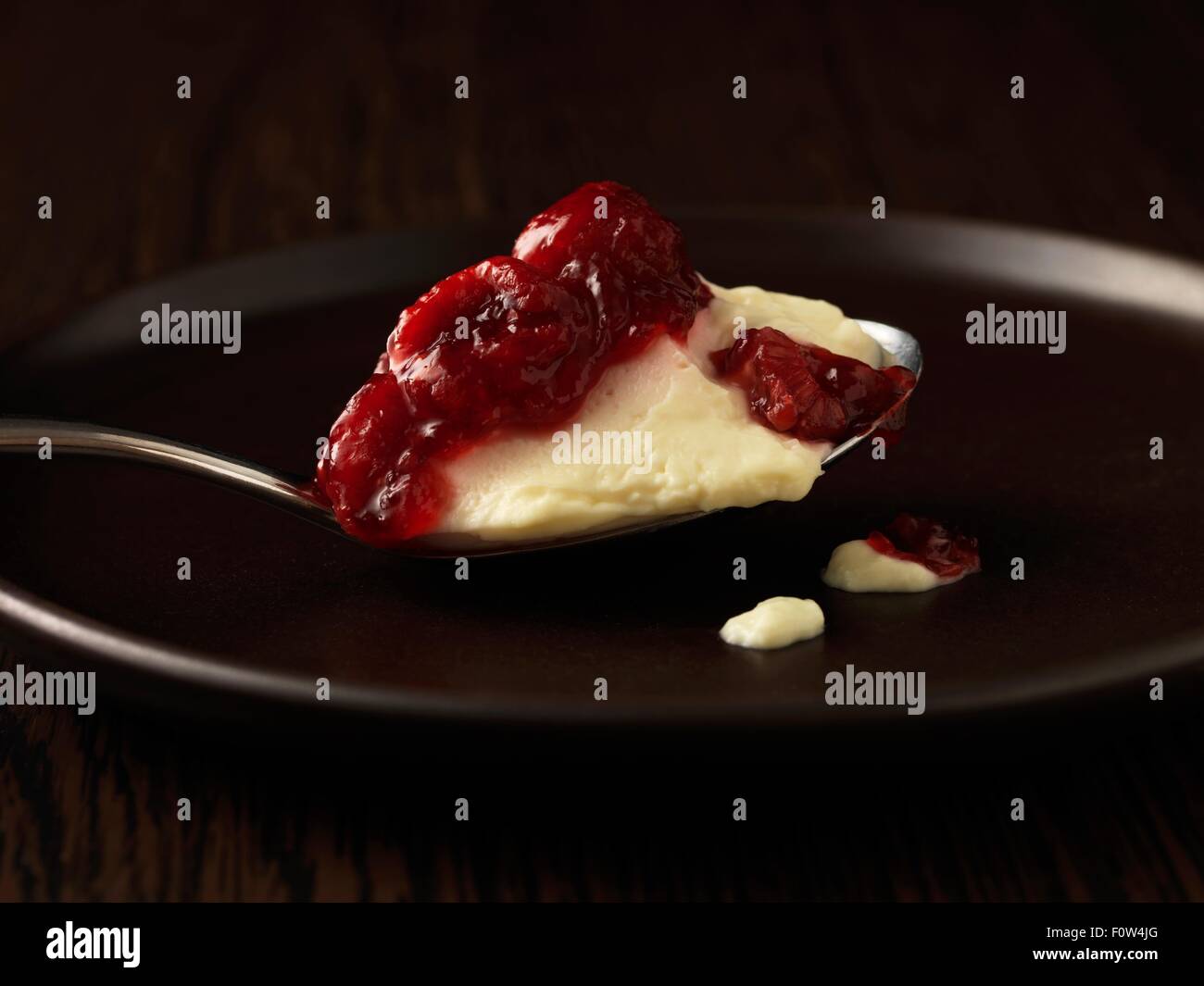Raspberry Panna Cotta on brown ceramic plate Stock Photo - Alamy