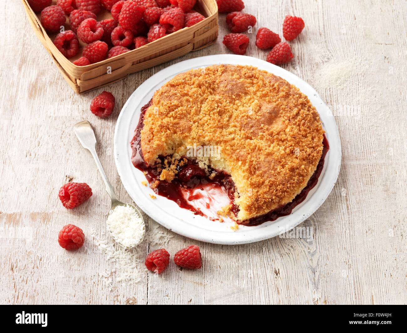 Raspberry and coconut macaroon on white ceramic plate Stock Photo - Alamy