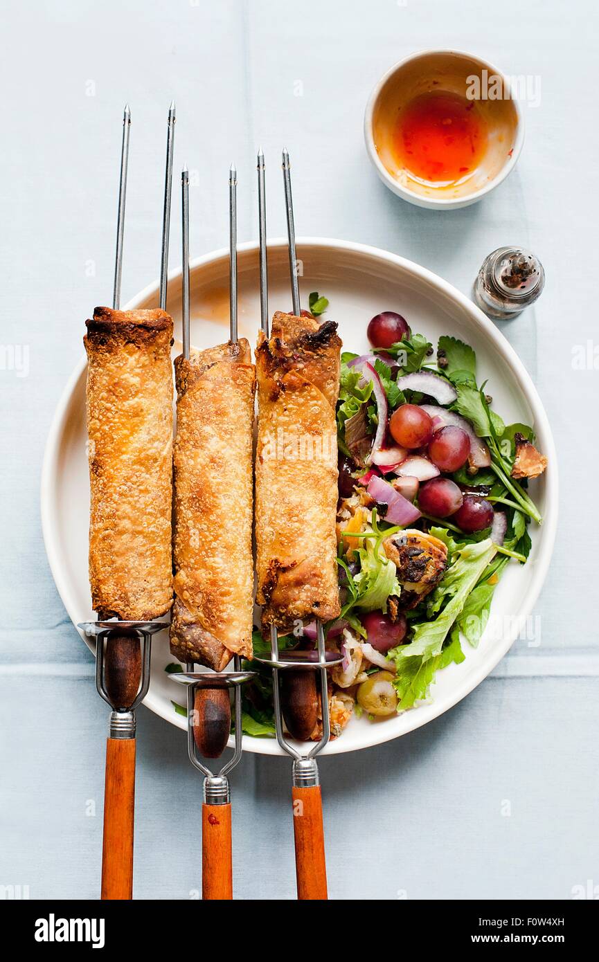 Spring rolls on skewers with salad and dipping sauce Stock Photo - Alamy