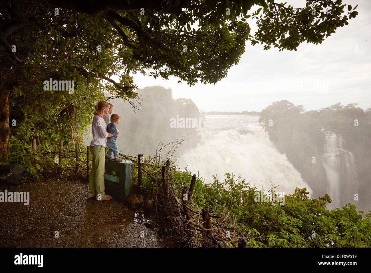 Mother and sons admiring view, Victoria Falls, Livingstone, Zimbabwe ...