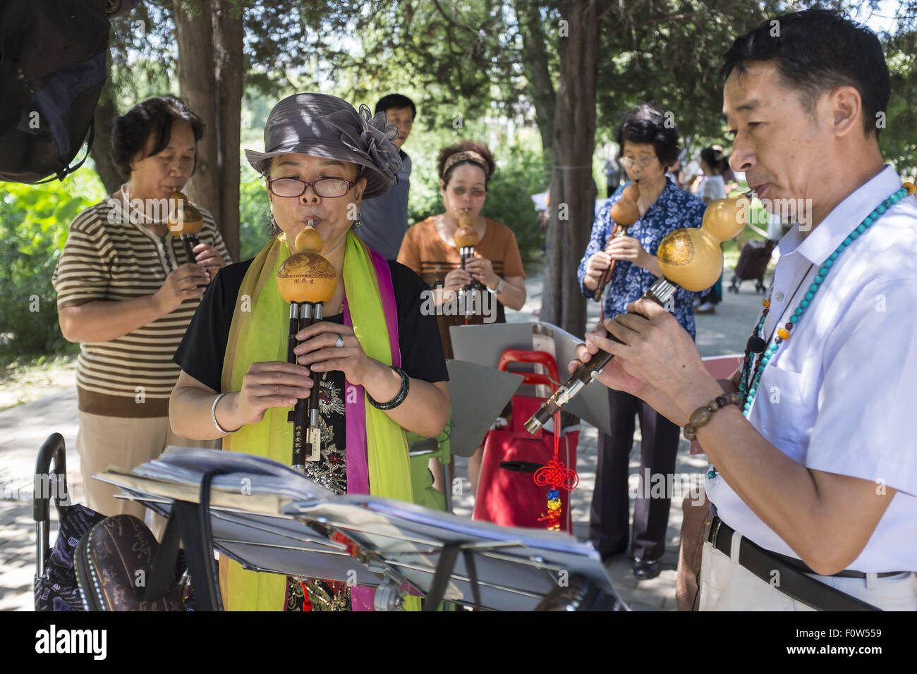 Beijing, China. 21st Aug, 2015. Elderly women learn how to play Hulusi ...