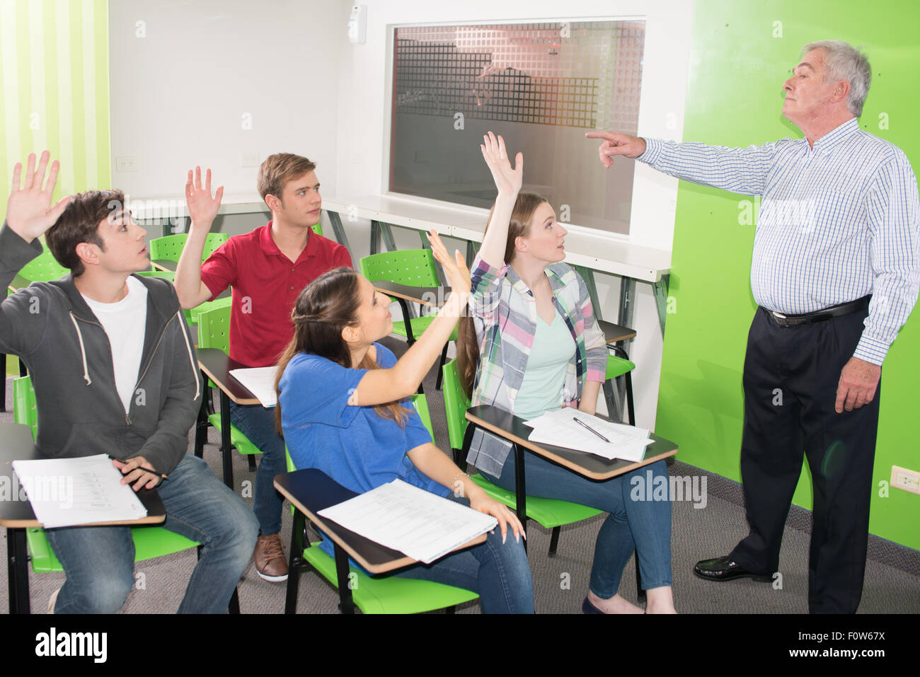 Students answering the teacher's question Stock Photo - Alamy