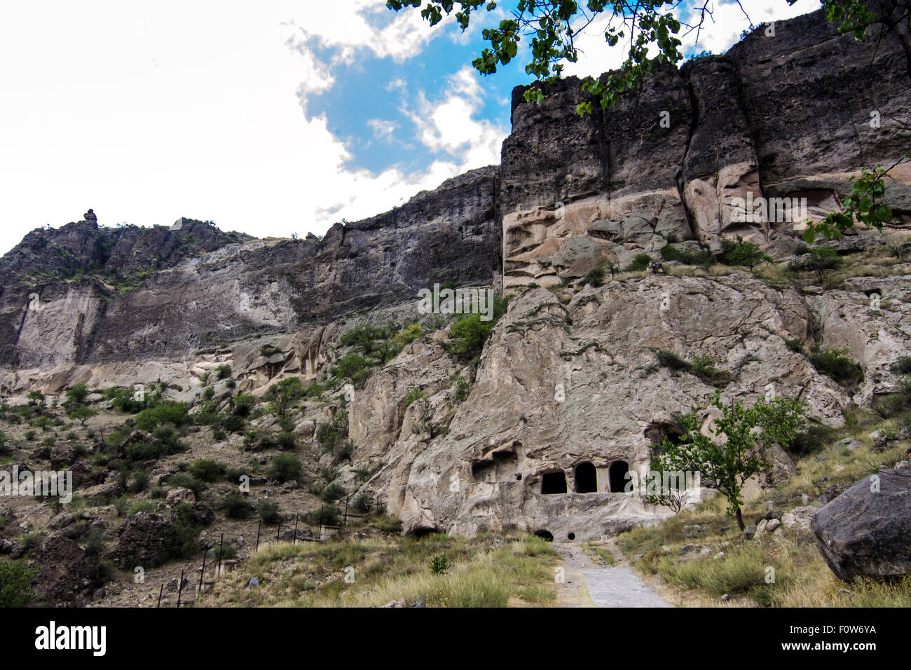 Ancient cave dwellings in mountains showcasing historical architecture ...