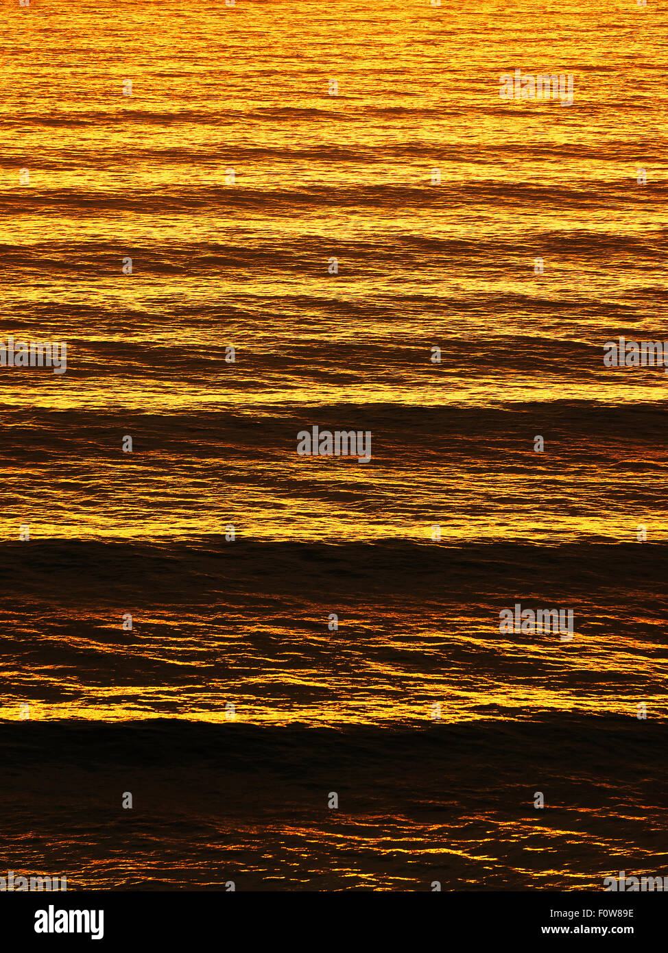 sea wave ripples at the sunset Stock Photo - Alamy