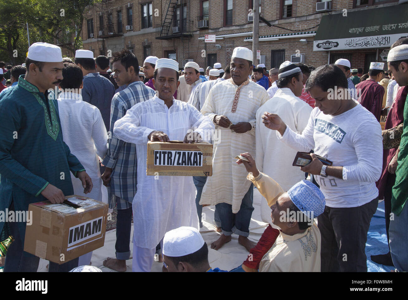 Muslims pray outside a mosque in Kensington, Brooklyn, NY for "Eid al ...