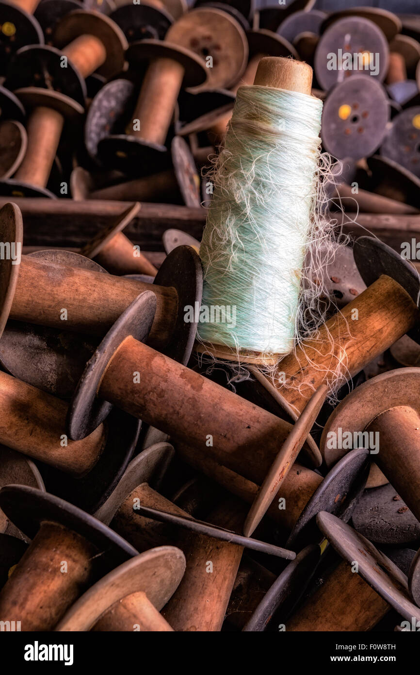 Silk Thread Spools - Silk thread spool surrounded with empty spools in ...