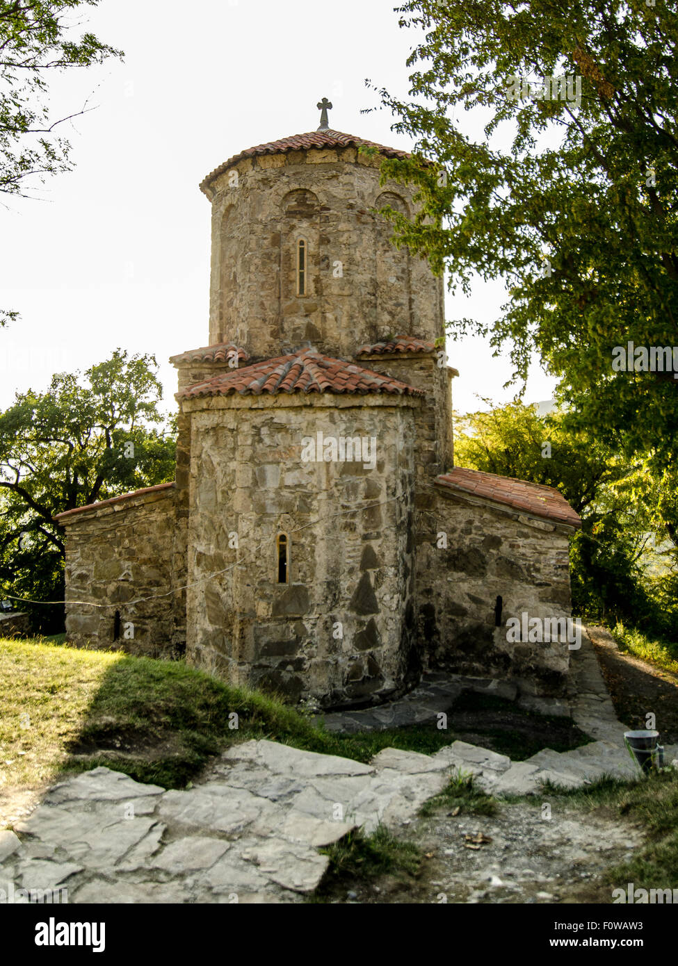 Historic brick church located on a hill surrounded by greenery during ...
