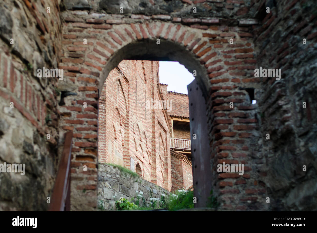 Exploring an ancient brick archway leading to historical structures in ...