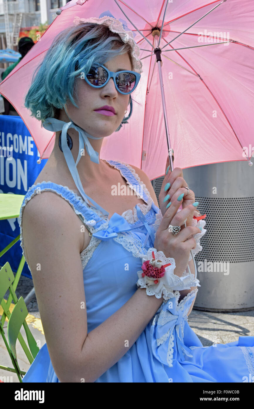 A performance artist dressed in light blue with light blue hair at ...