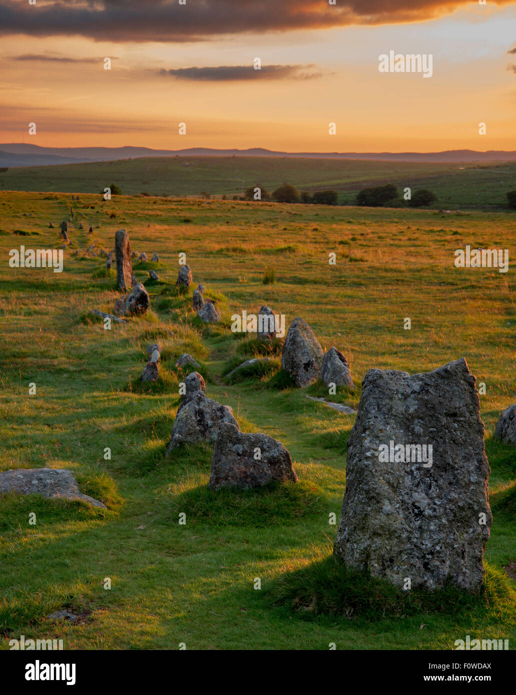 Sun setting behind the stone rows at Merrivale on Dartmoor Stock Photo ...