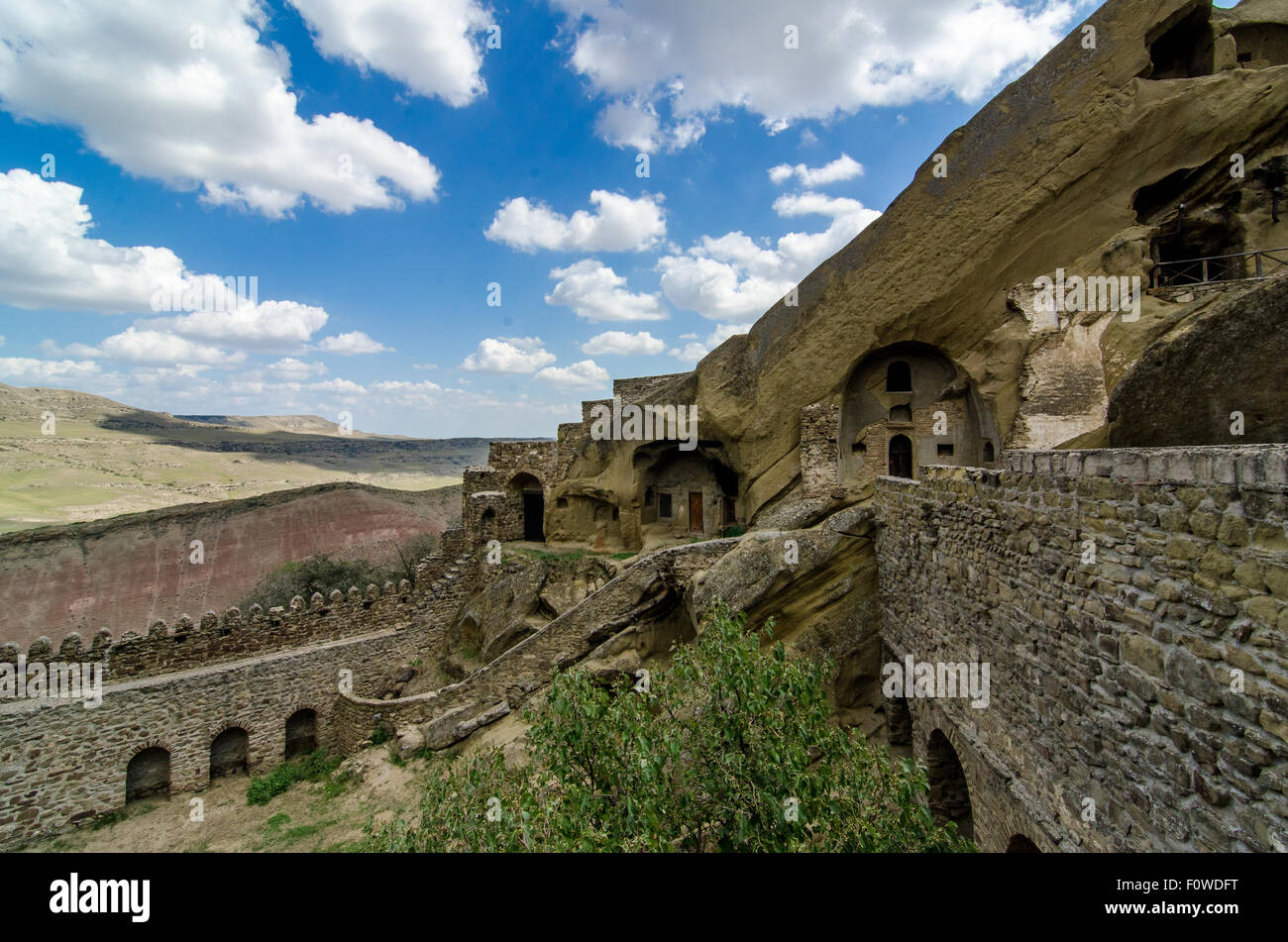 Ancient stone buildings beneath a bright sky with clouds in a historic ...