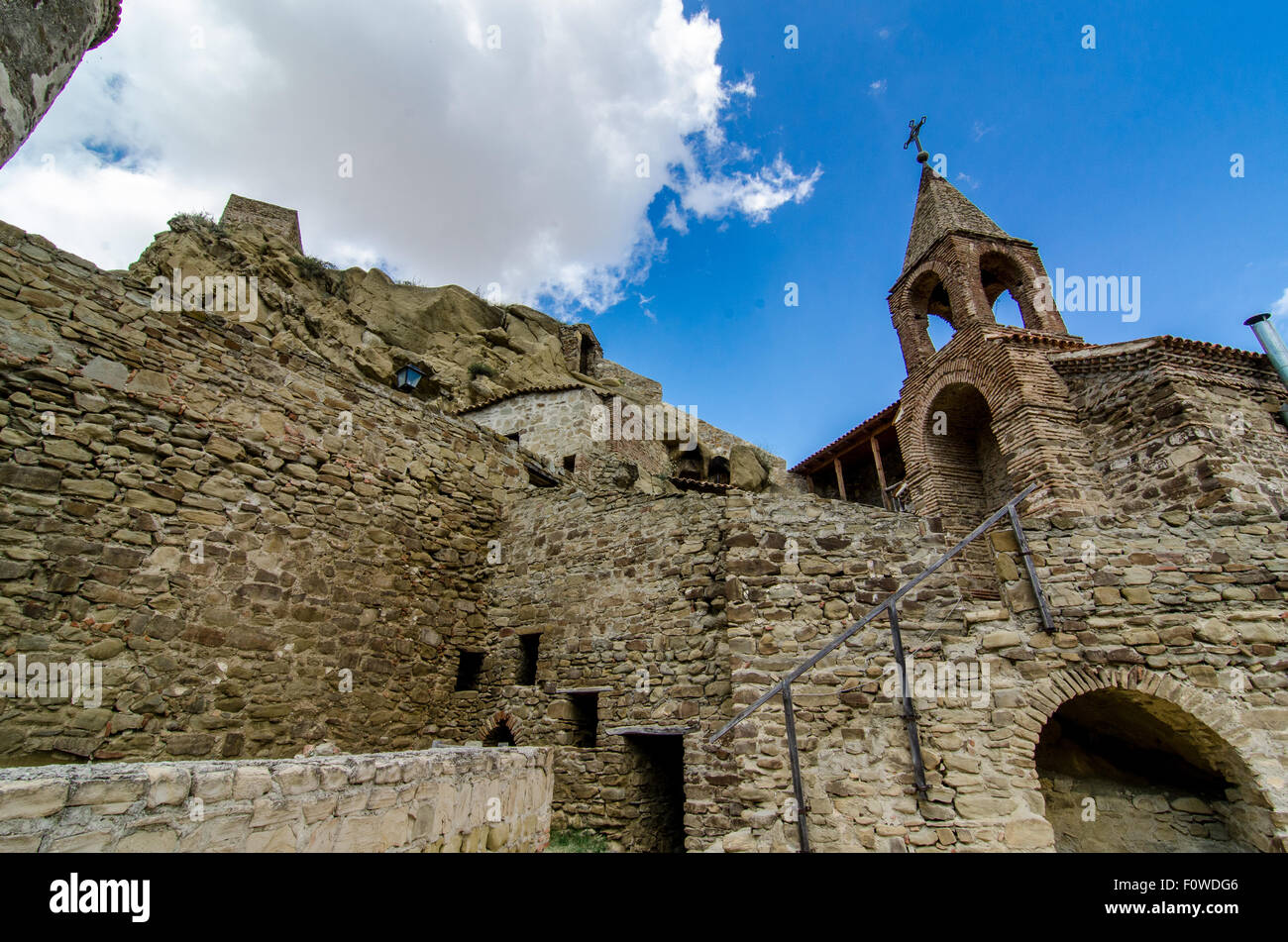 Ancient stone buildings beneath a bright sky with clouds in a historic ...