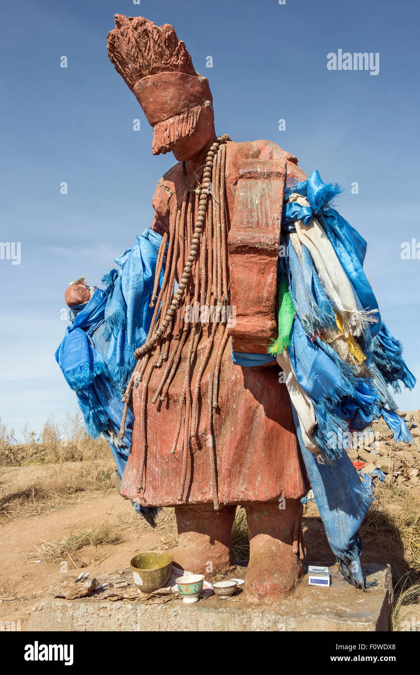 Mongolian Tengerism shaman statue with blue silk prayer scarves, near ...