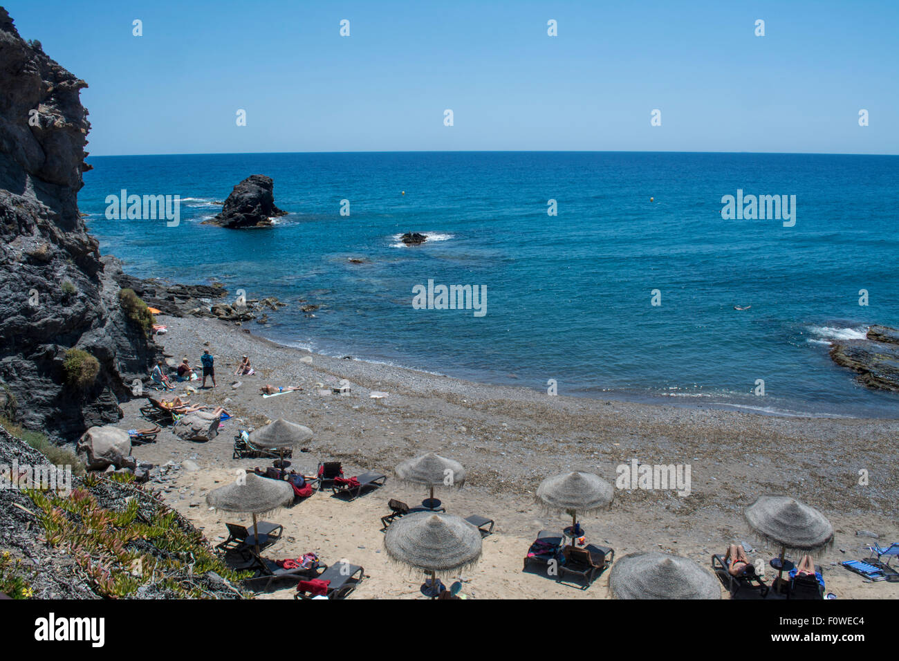 Sunbeds and umbrellas on the Cala del Barco Bay beach at La Manga Club ...