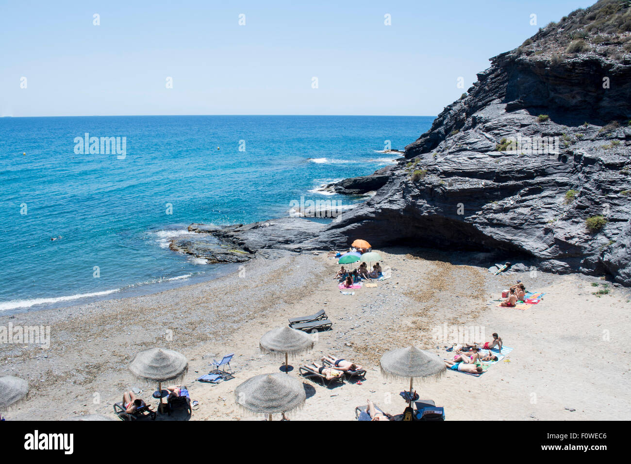 Sunbeds and umbrellas on the Cala del Barco Bay beach at La Manga Club ...