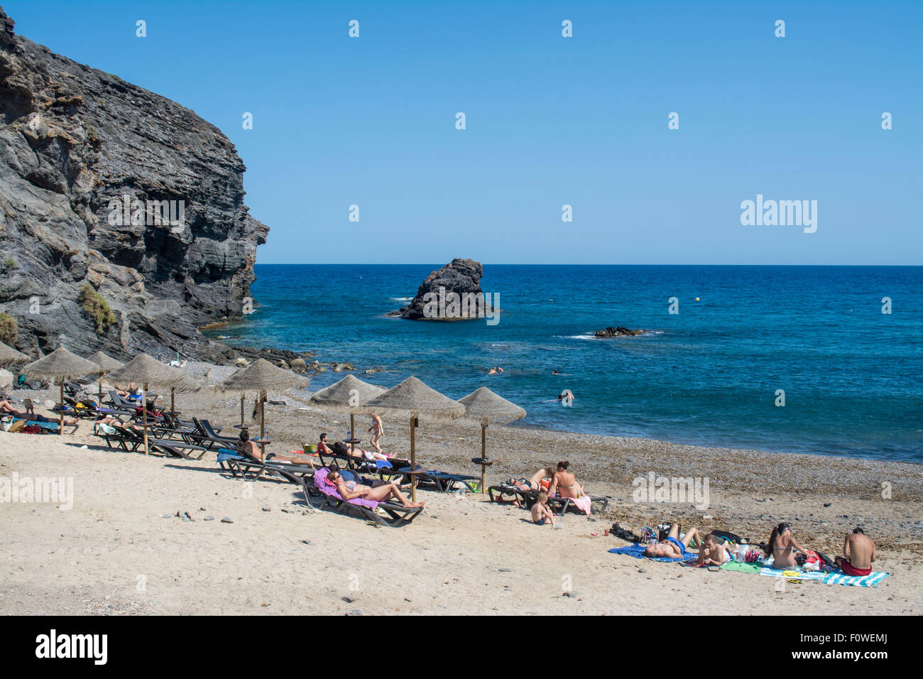 Sunbeds and umbrellas on the Cala del Barco Bay beach at La Manga Club ...