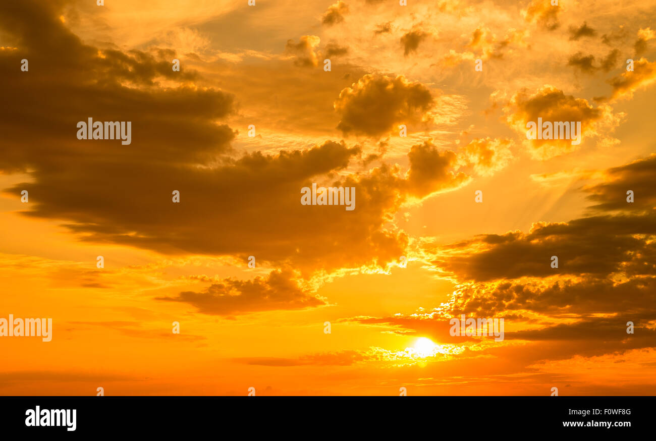 Amazing gold sunset with fluffy clouds in the sky Stock Photo - Alamy