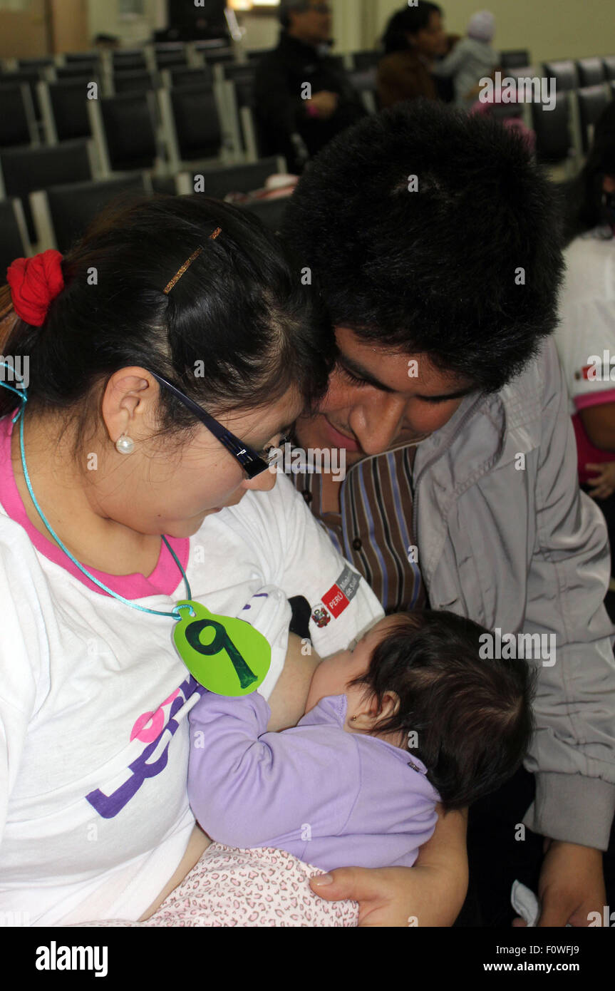 Lima, Peru. 21st Aug, 2015. A mother breastfeeds her child during the ...