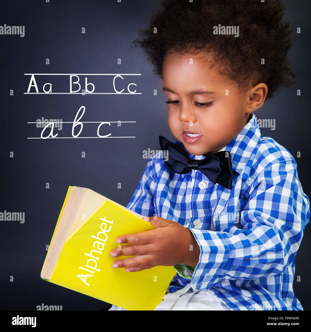 Little boy on language lesson, holding in hands alphabet, learning ...