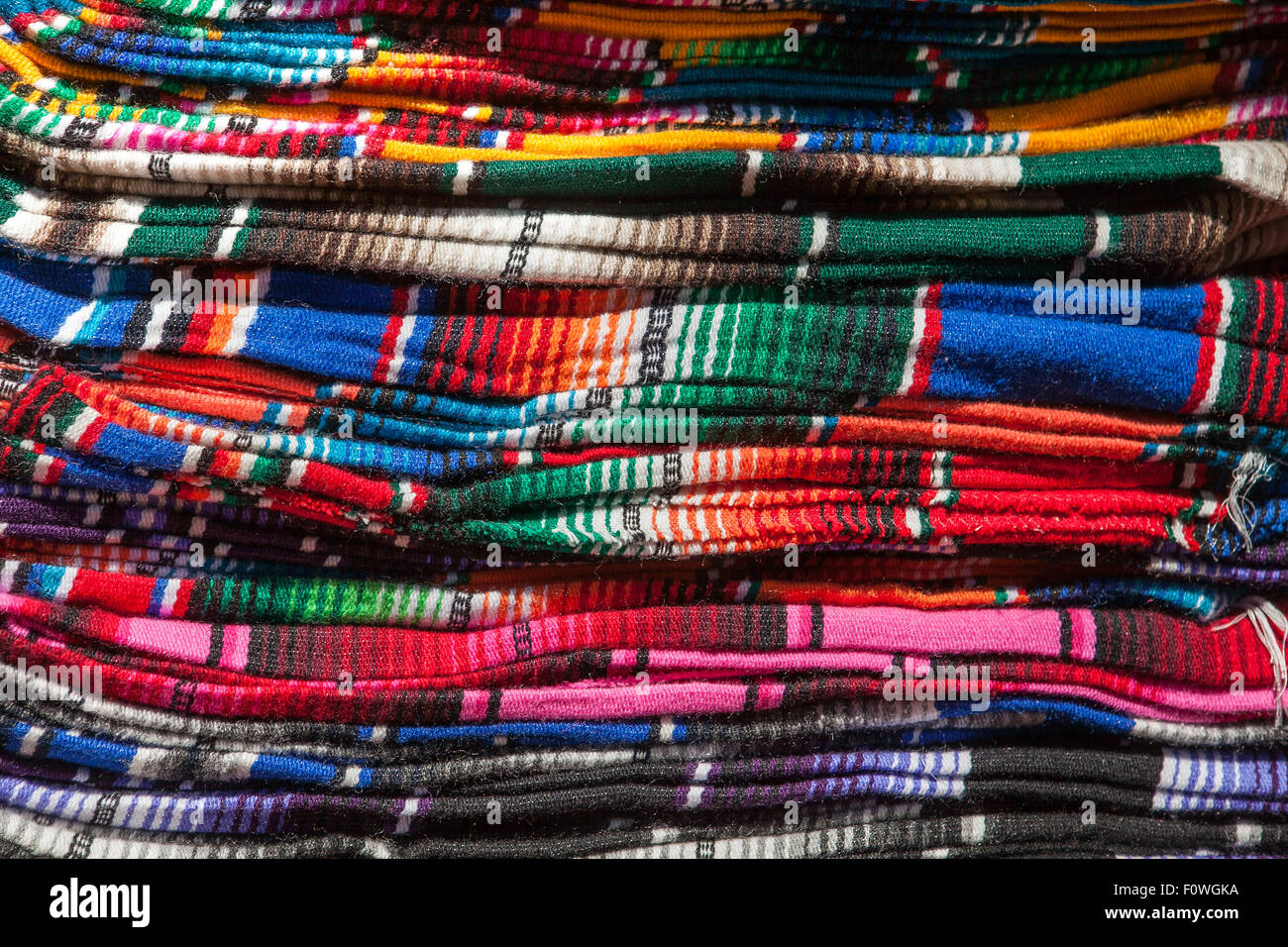 Colorful Mexican serapes hang in row Stock Photo - Alamy