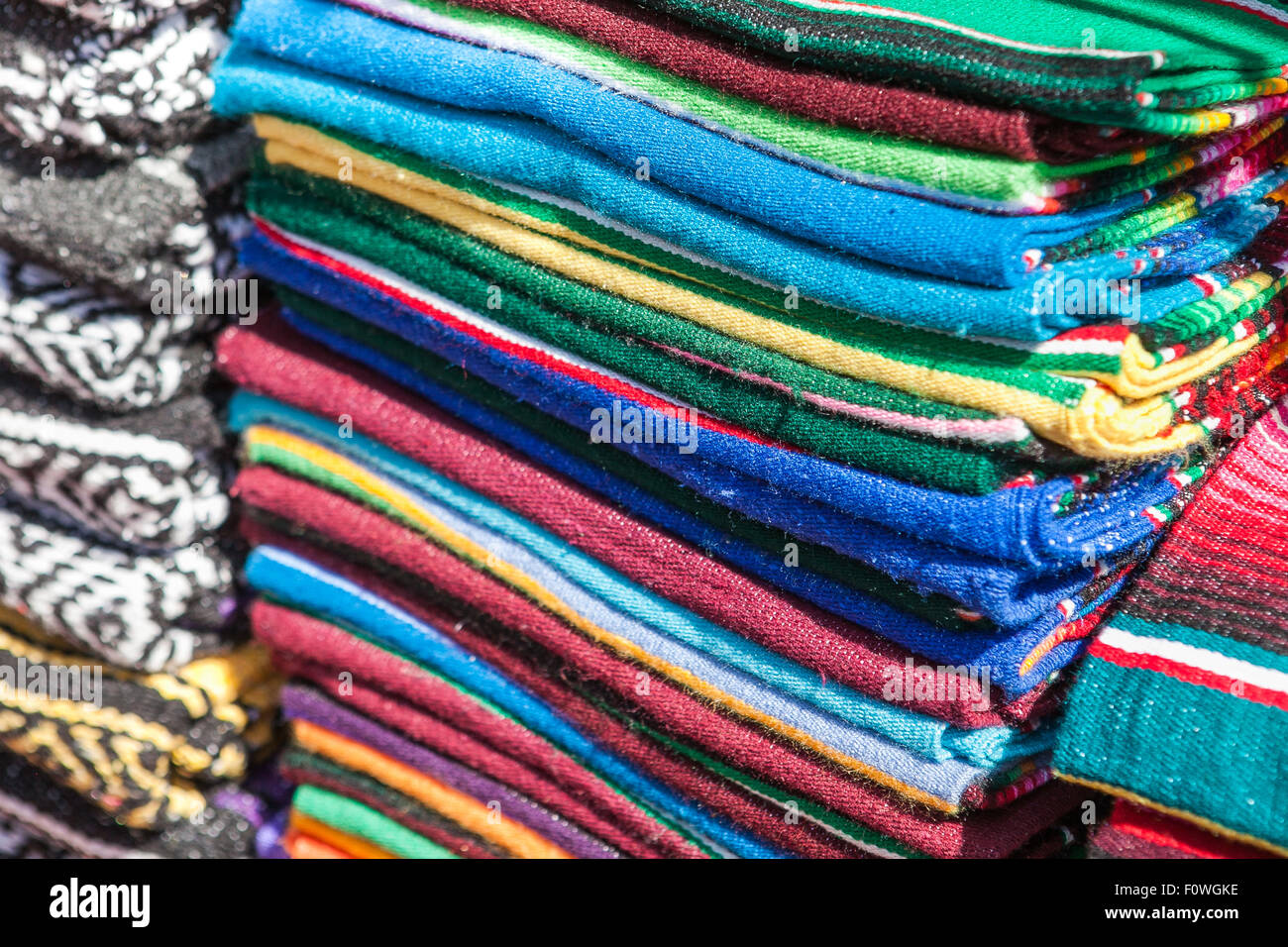 Colorful Mexican serapes hang in row. Great for background Stock Photo ...