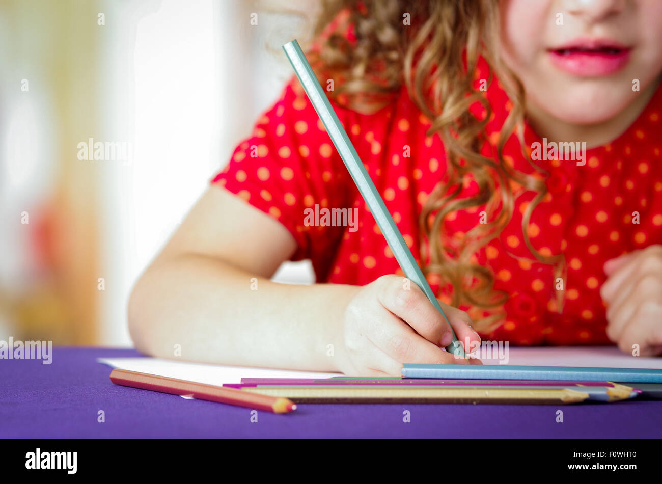 Sweet preschooler girl using colored pencils Stock Photo - Alamy