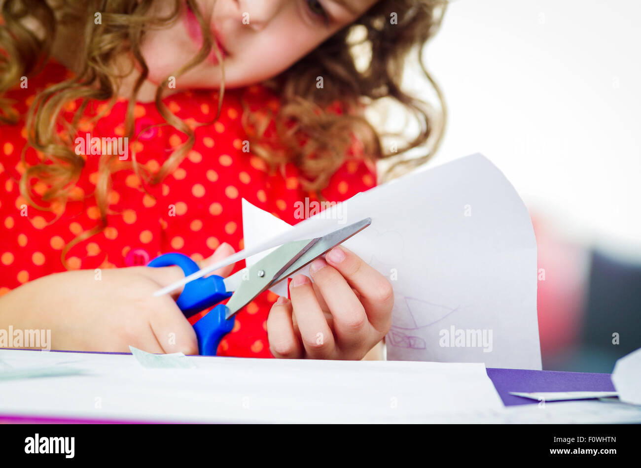 Little girls' hands using scissors Stock Photo - Alamy