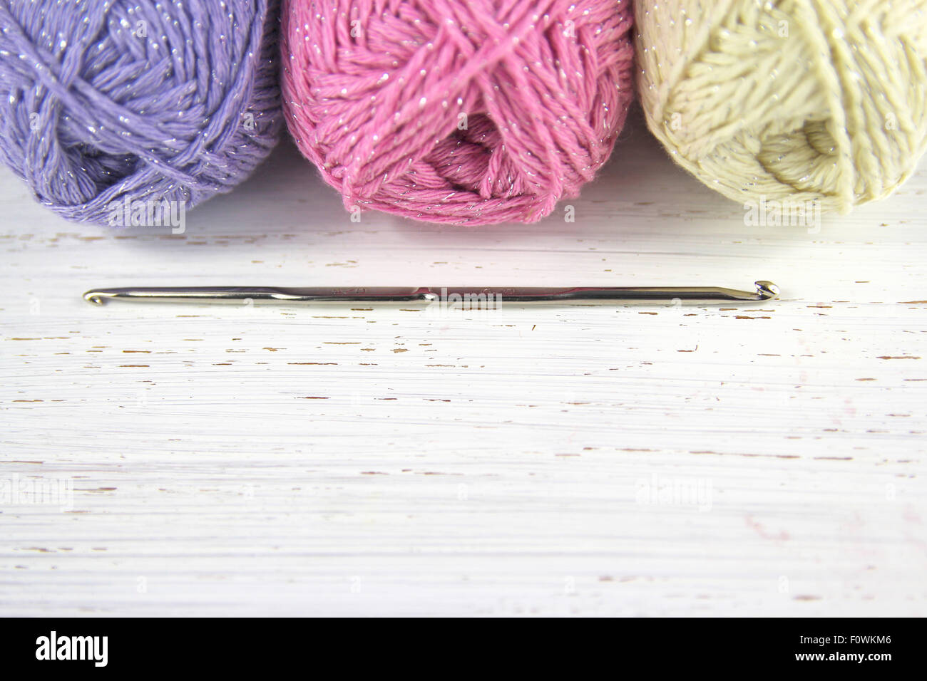 Yarn Wool pastel colours with crochet hook and copy space on distressed ...