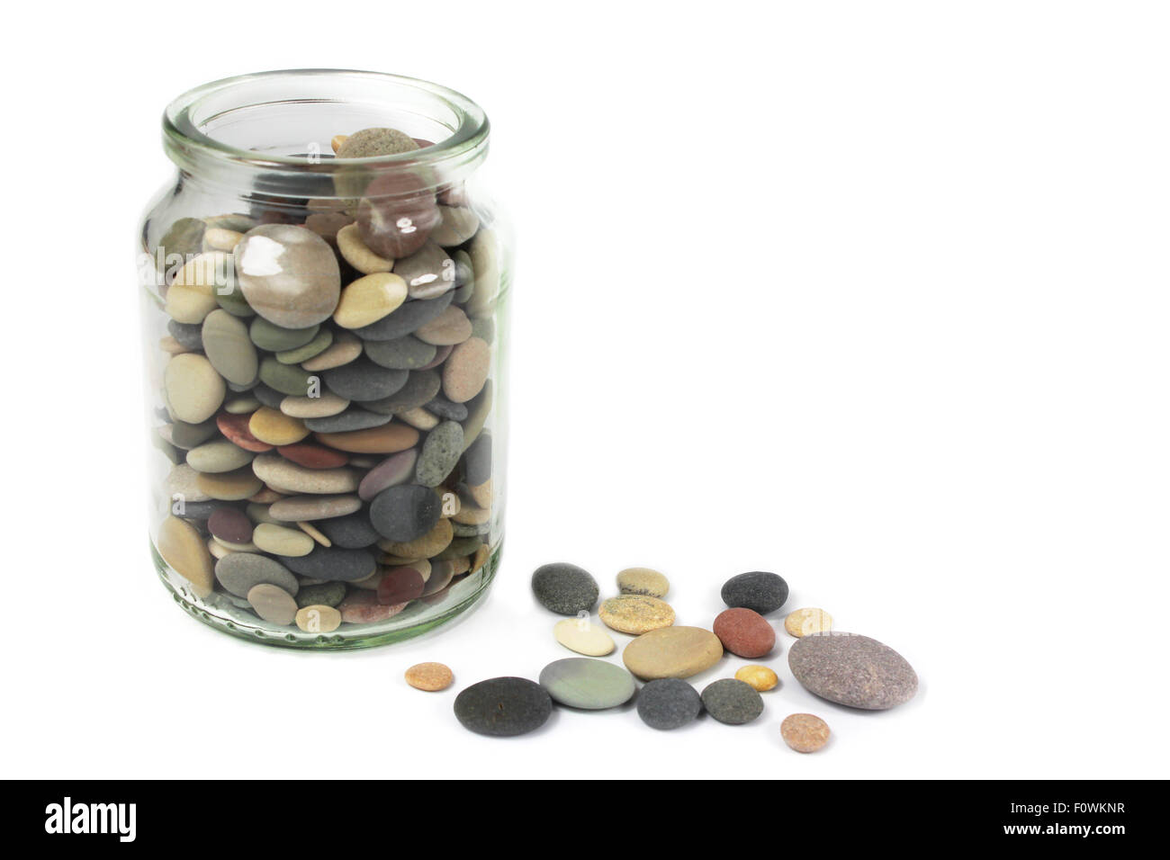 Pebbles or Beach stones in a glass jar on white background Stock Photo ...
