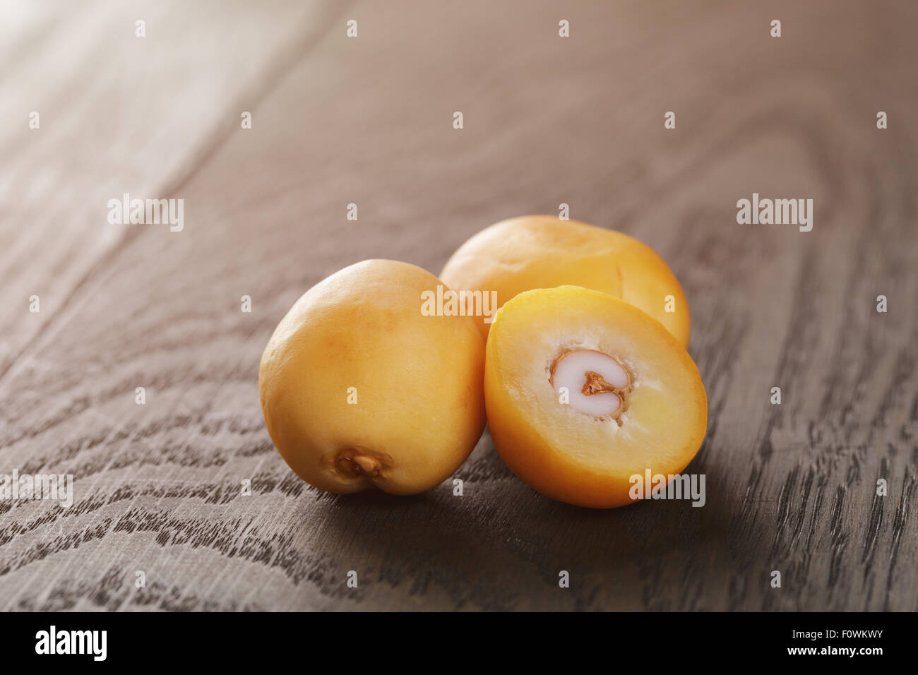 fresh raw dates on table old oak wood Stock Photo - Alamy