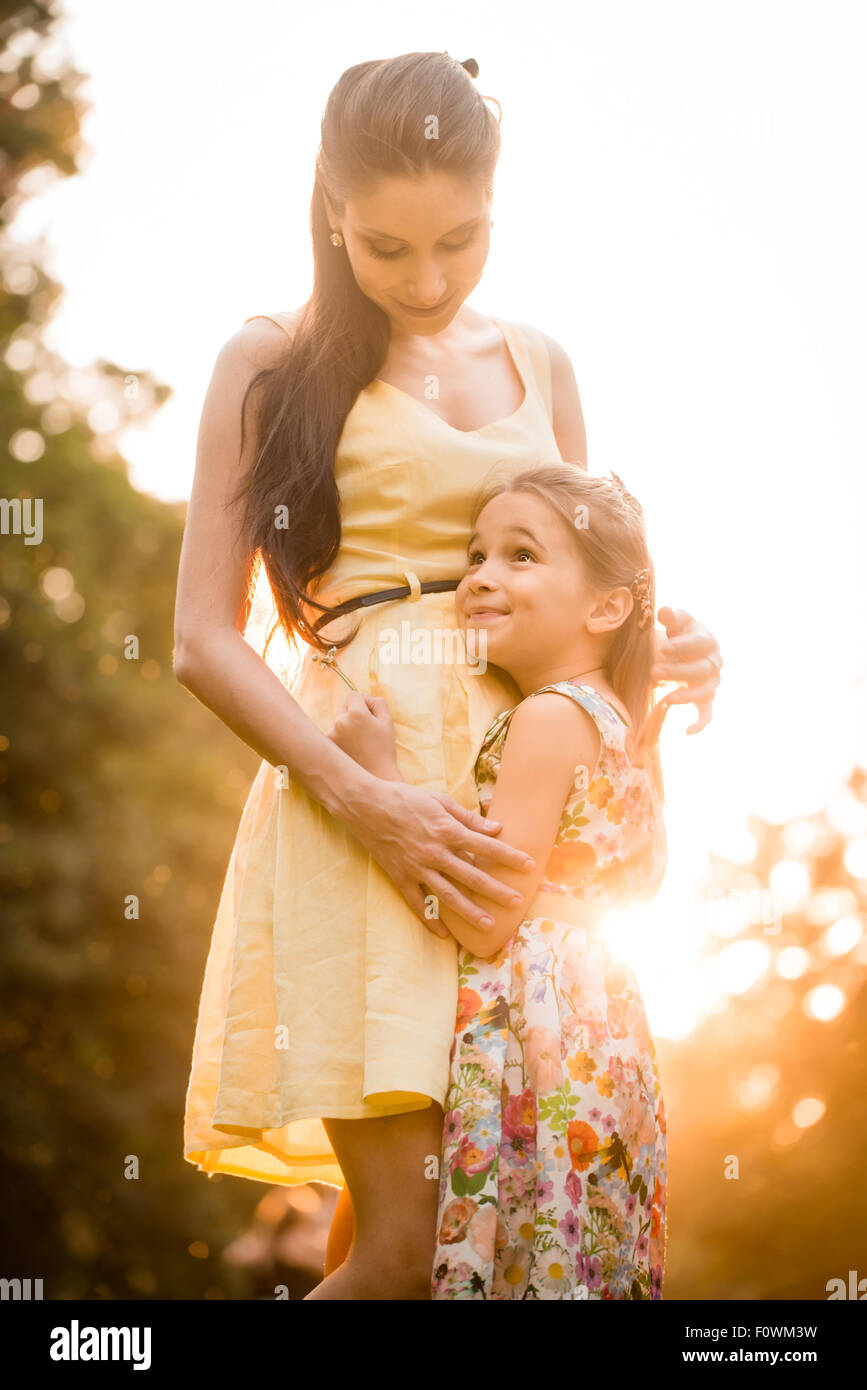 Child embracing her precious mother in nature at sunset Stock Photo - Alamy