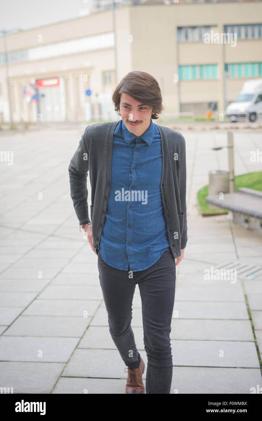 Young beautiful caucasian brown hair man with moustache walking posing ...