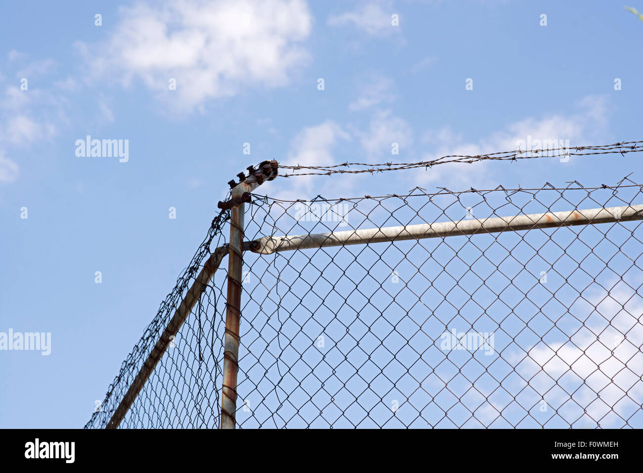 Fence with barbed wire on top Stock Photo - Alamy