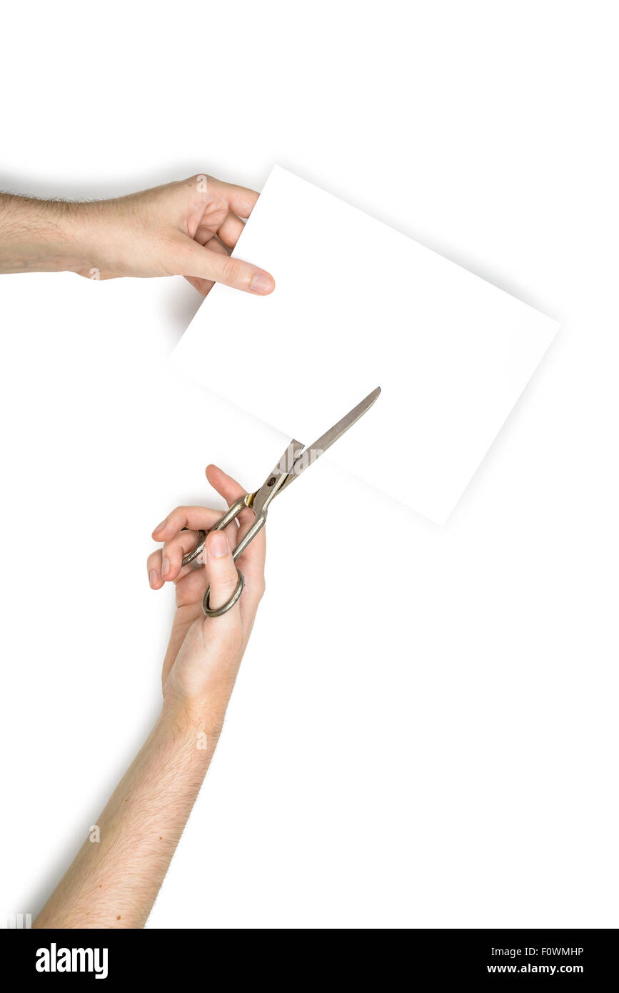 A woman is cutting a sheet of white paper using metallic scissors ...