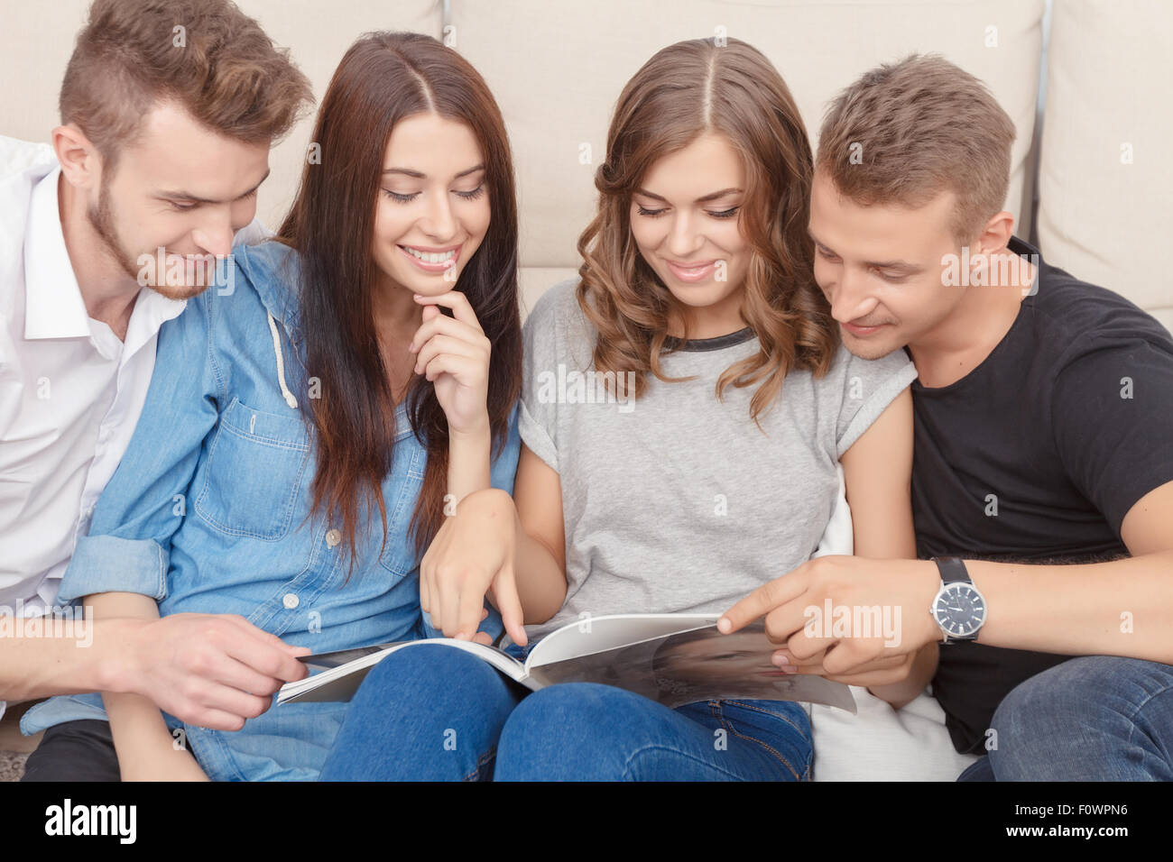 Happy friend reading magazine Stock Photo - Alamy