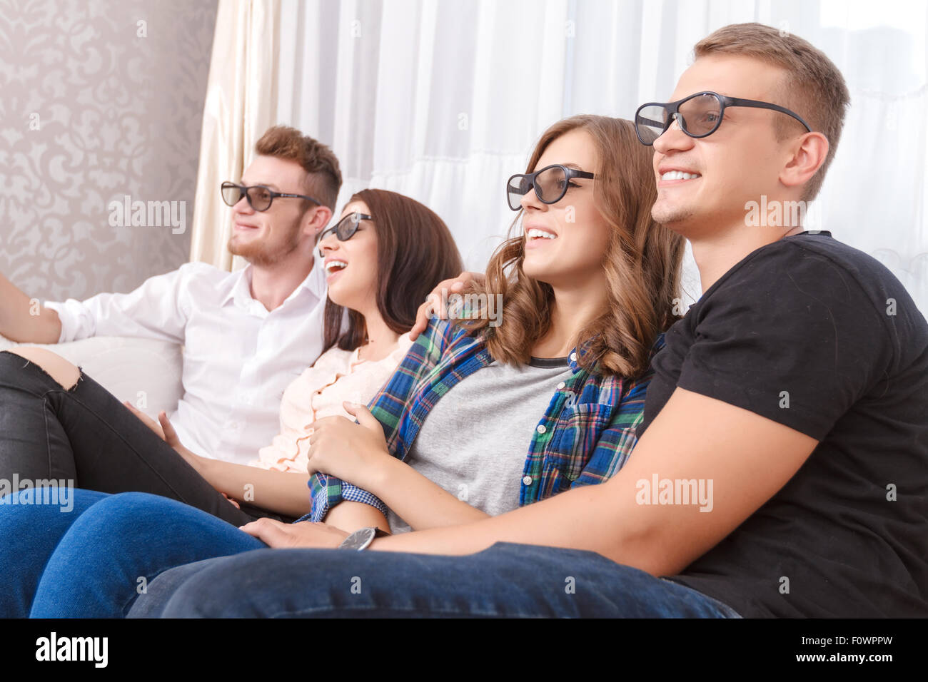 Emotional friends watching film Stock Photo - Alamy