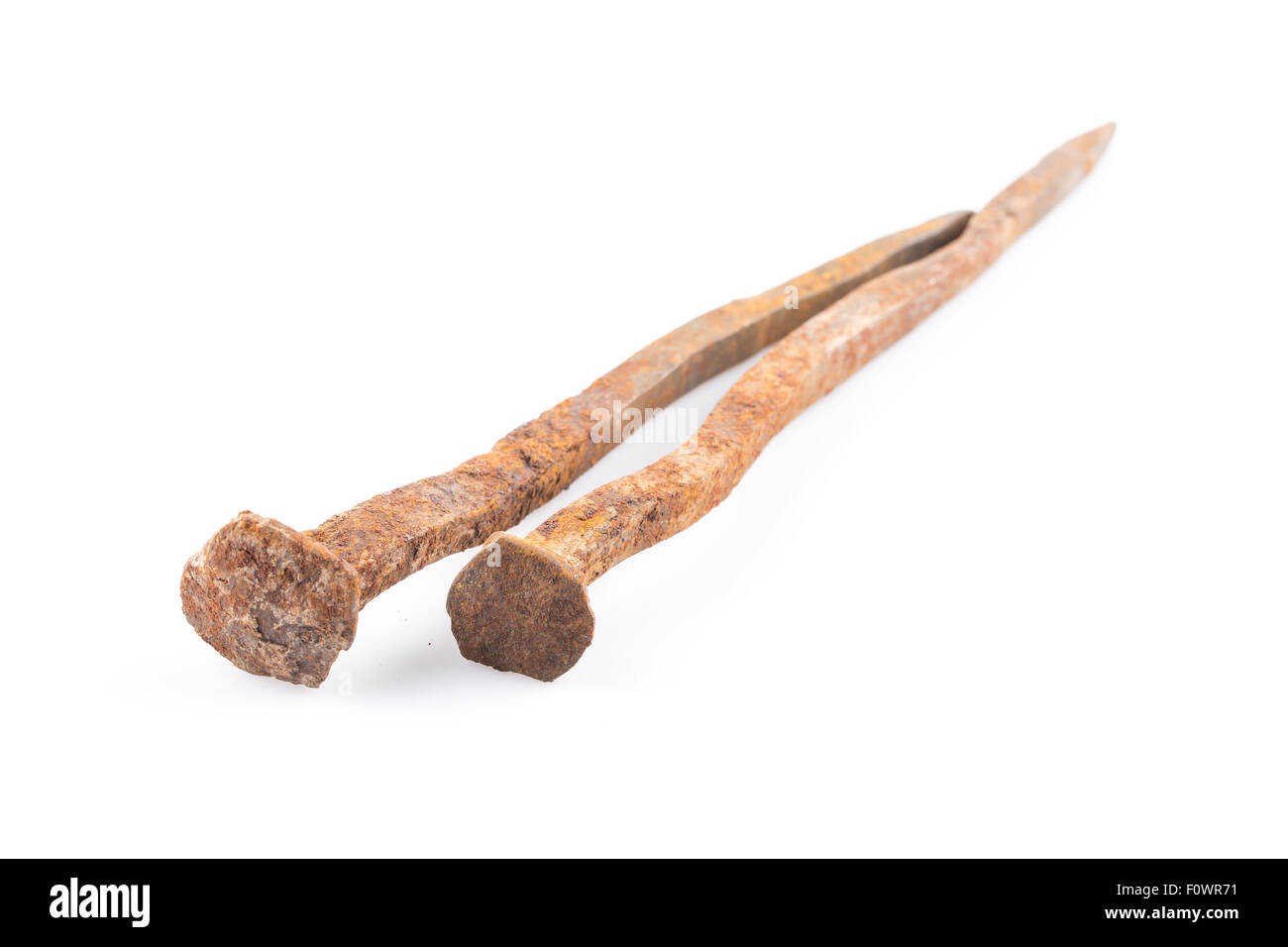 some old rusty nails on white table Stock Photo - Alamy